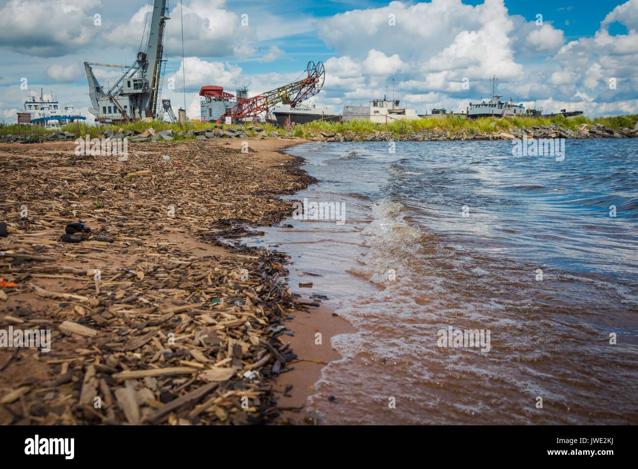 A view of the shore and the waves next to the cargo port Stock Photo ...
