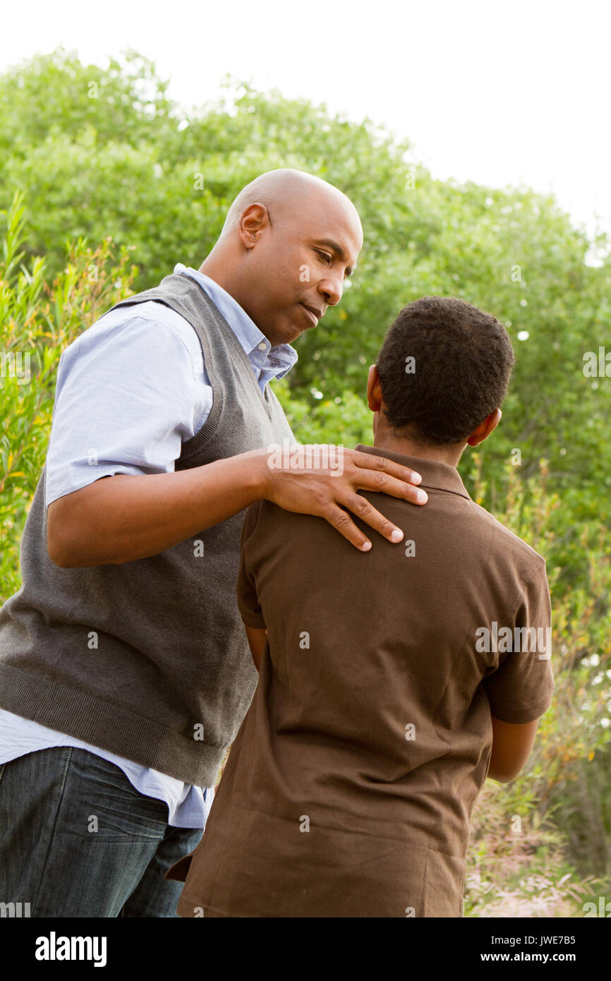 Father comforting his son Stock Photo - Alamy