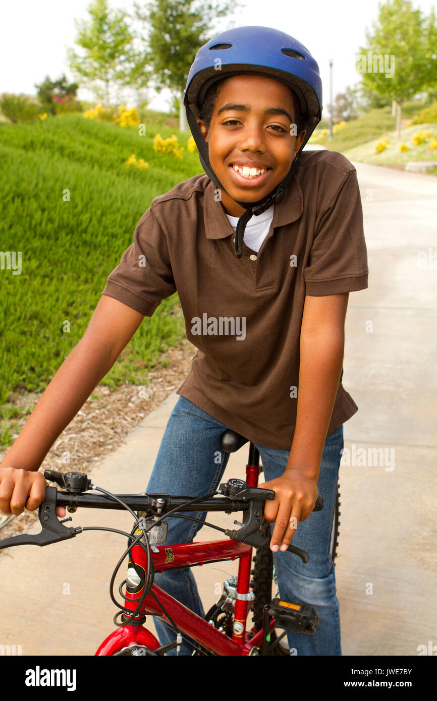 Happy young boy riding a bike Stock Photo - Alamy