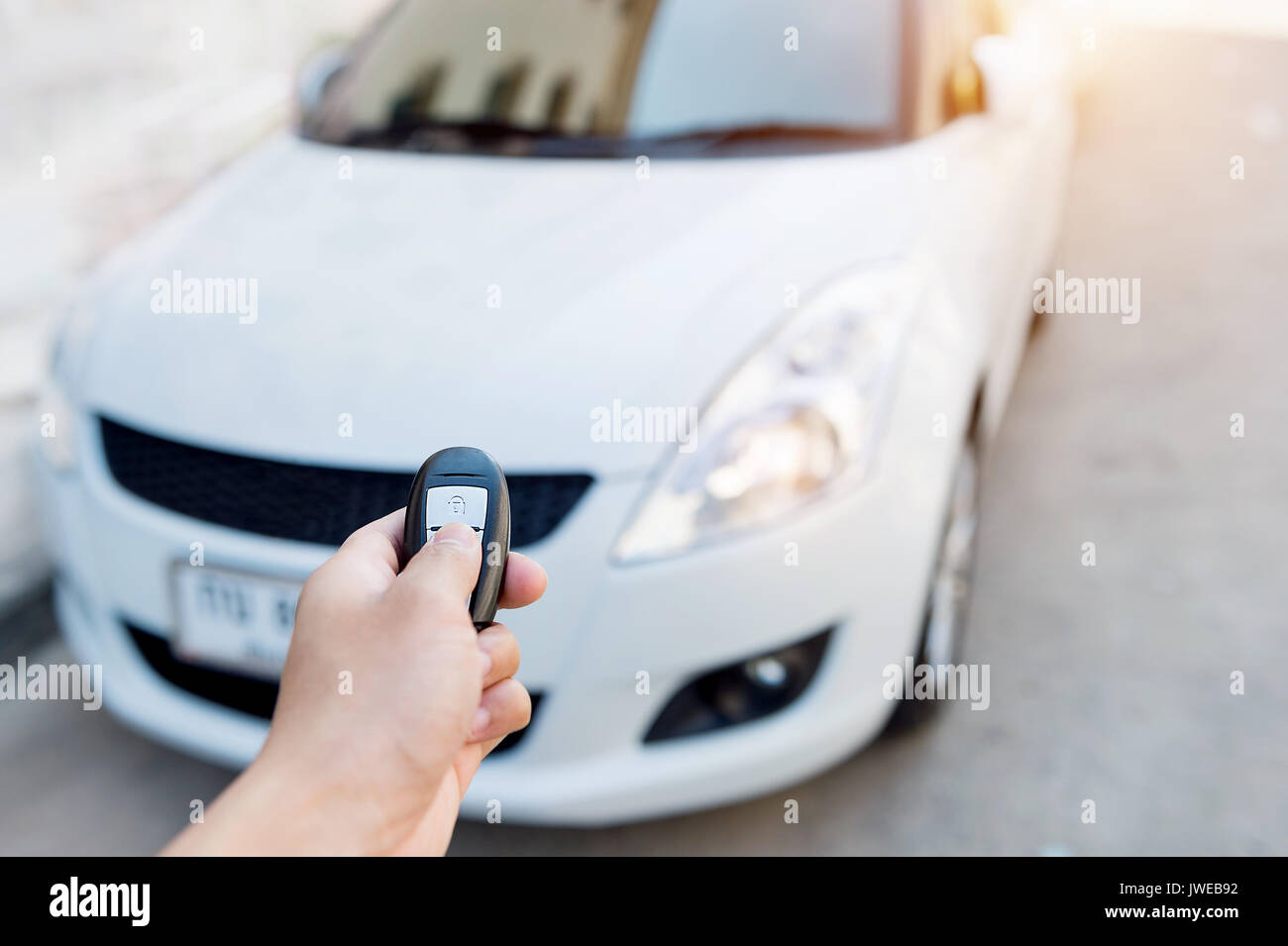 Hand holding car's remote control Stock Photo - Alamy