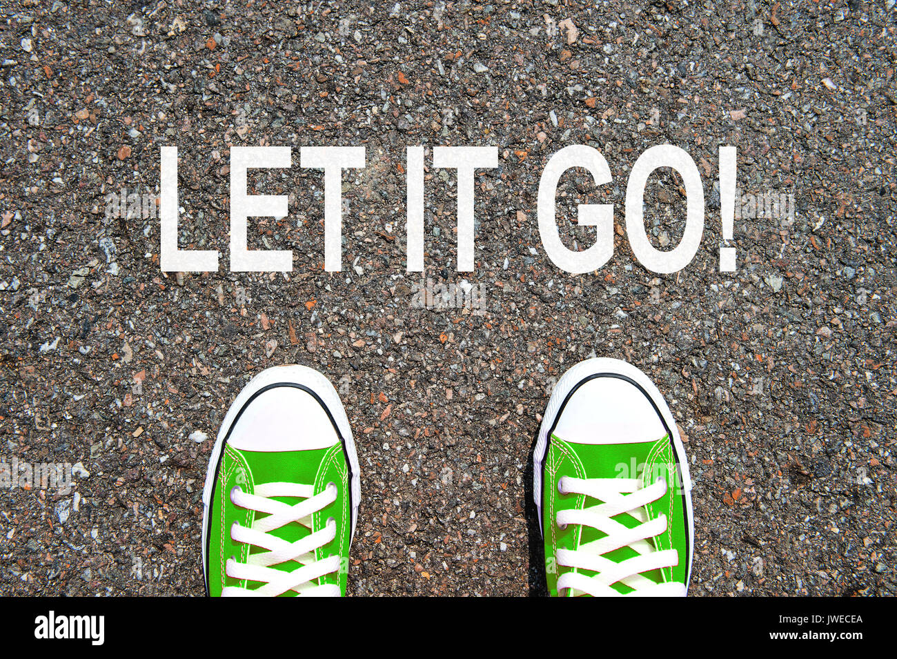 Feet concept with green sneakers on black background with let it go ...