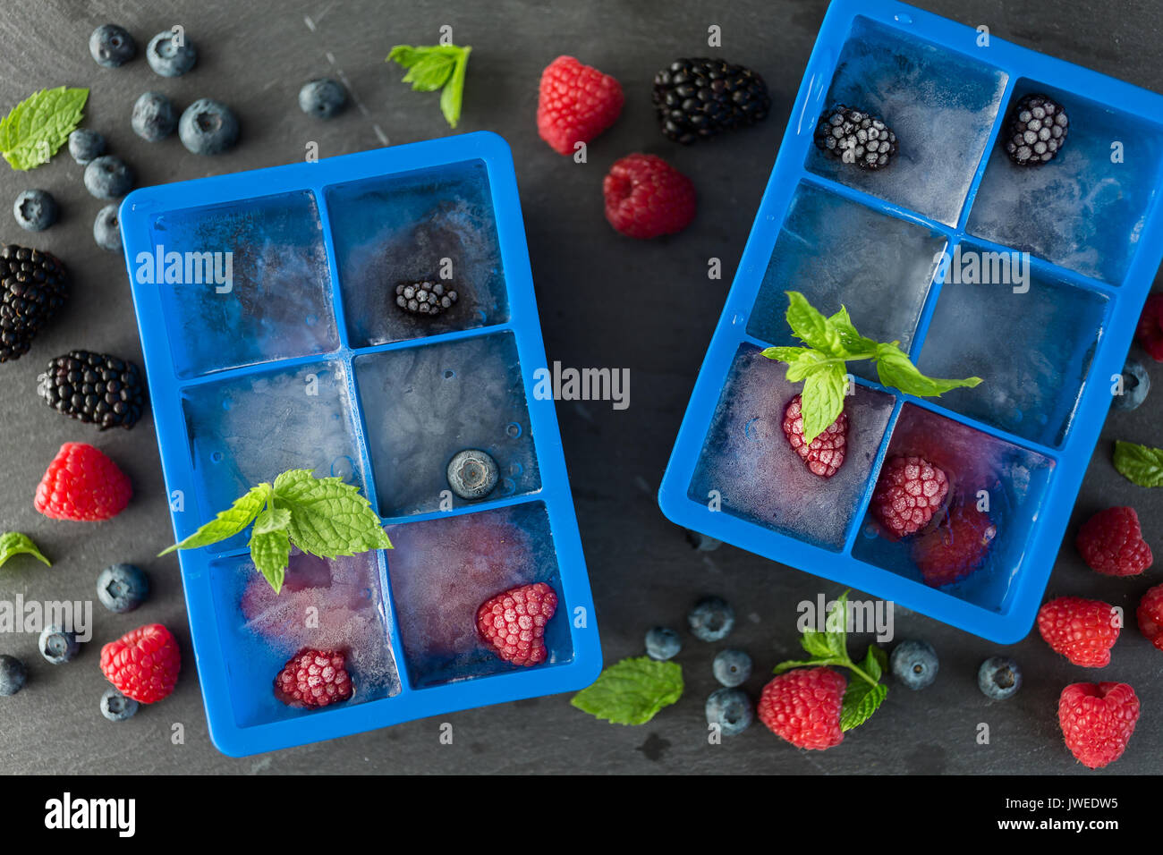 Fruit ice cubes with organic berries Stock Photo - Alamy