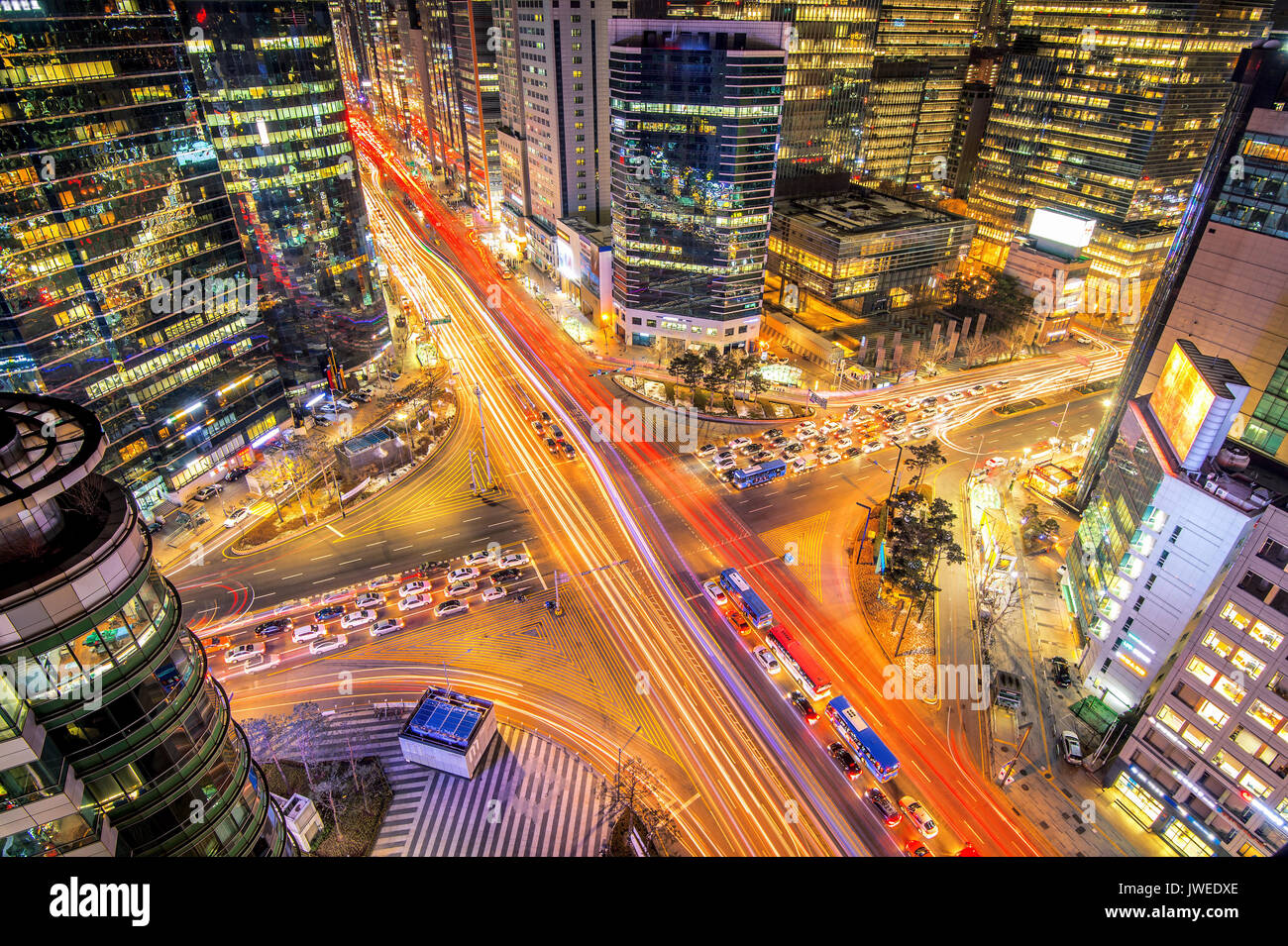 Cityscape of South Korea. Night traffic speeds through an intersection ...