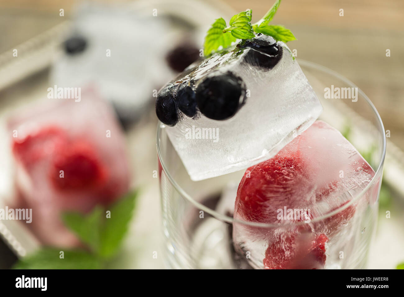 Fruit ice cubes with organic berries Stock Photo - Alamy