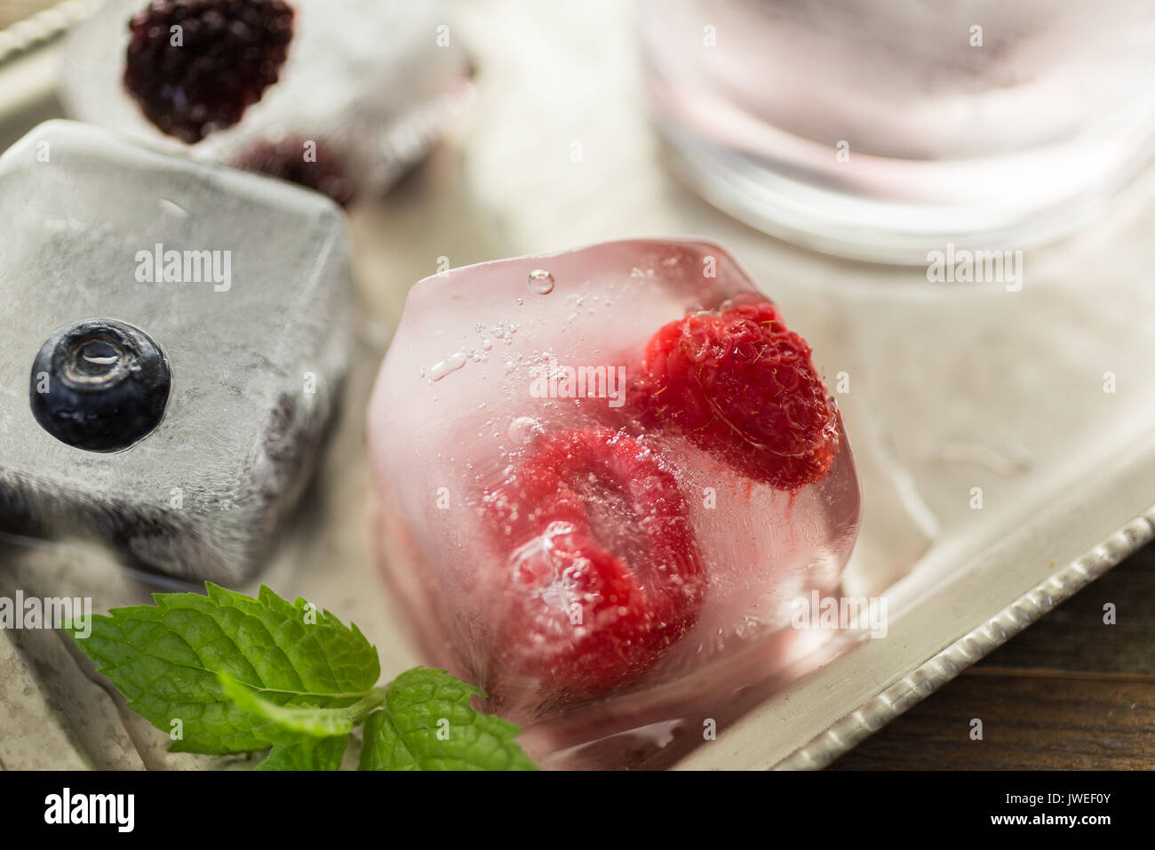 Fruit ice cubes with organic berries Stock Photo - Alamy