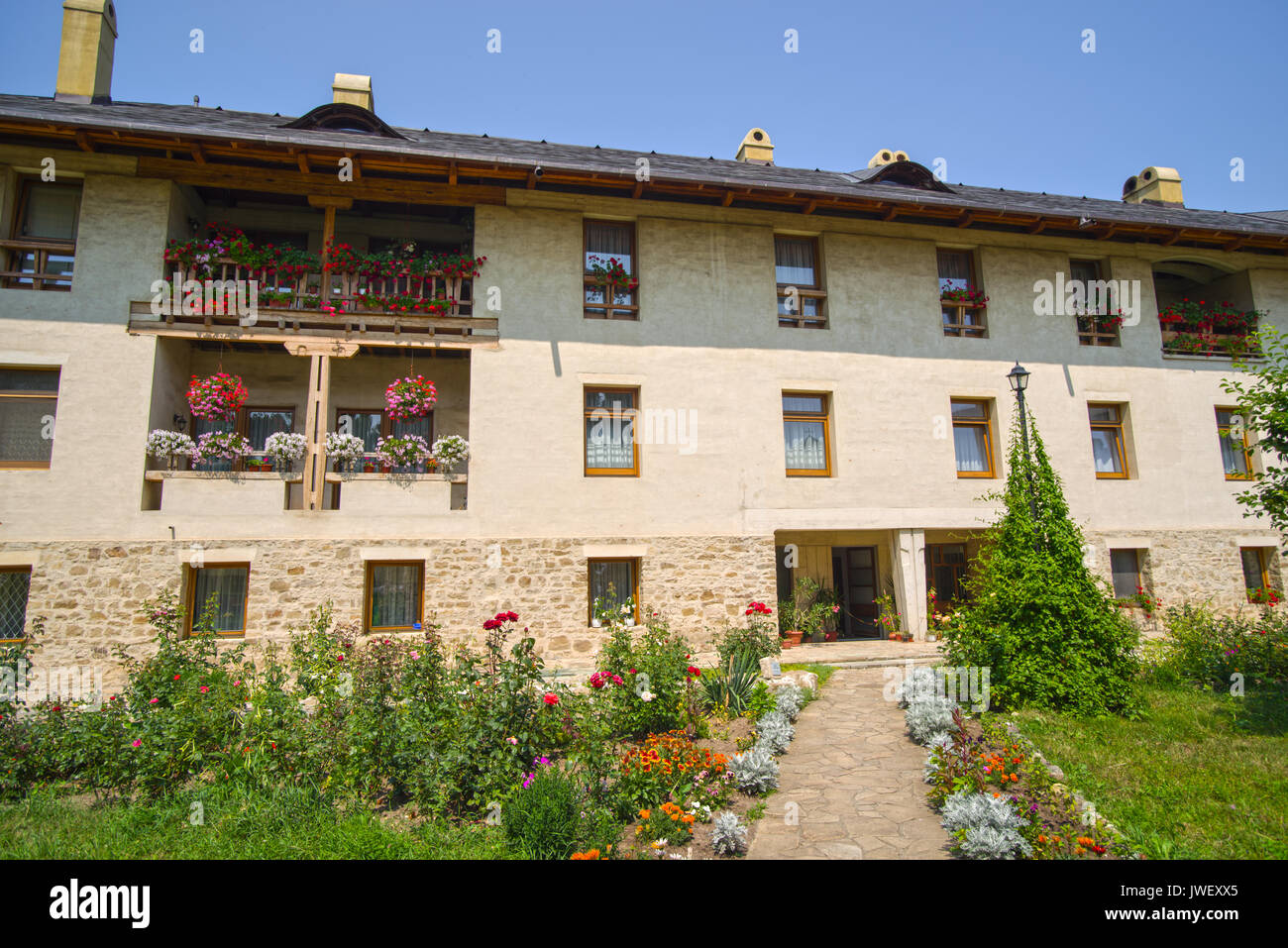 Flower garden and traditional orthodox monastery in Bucovina ...