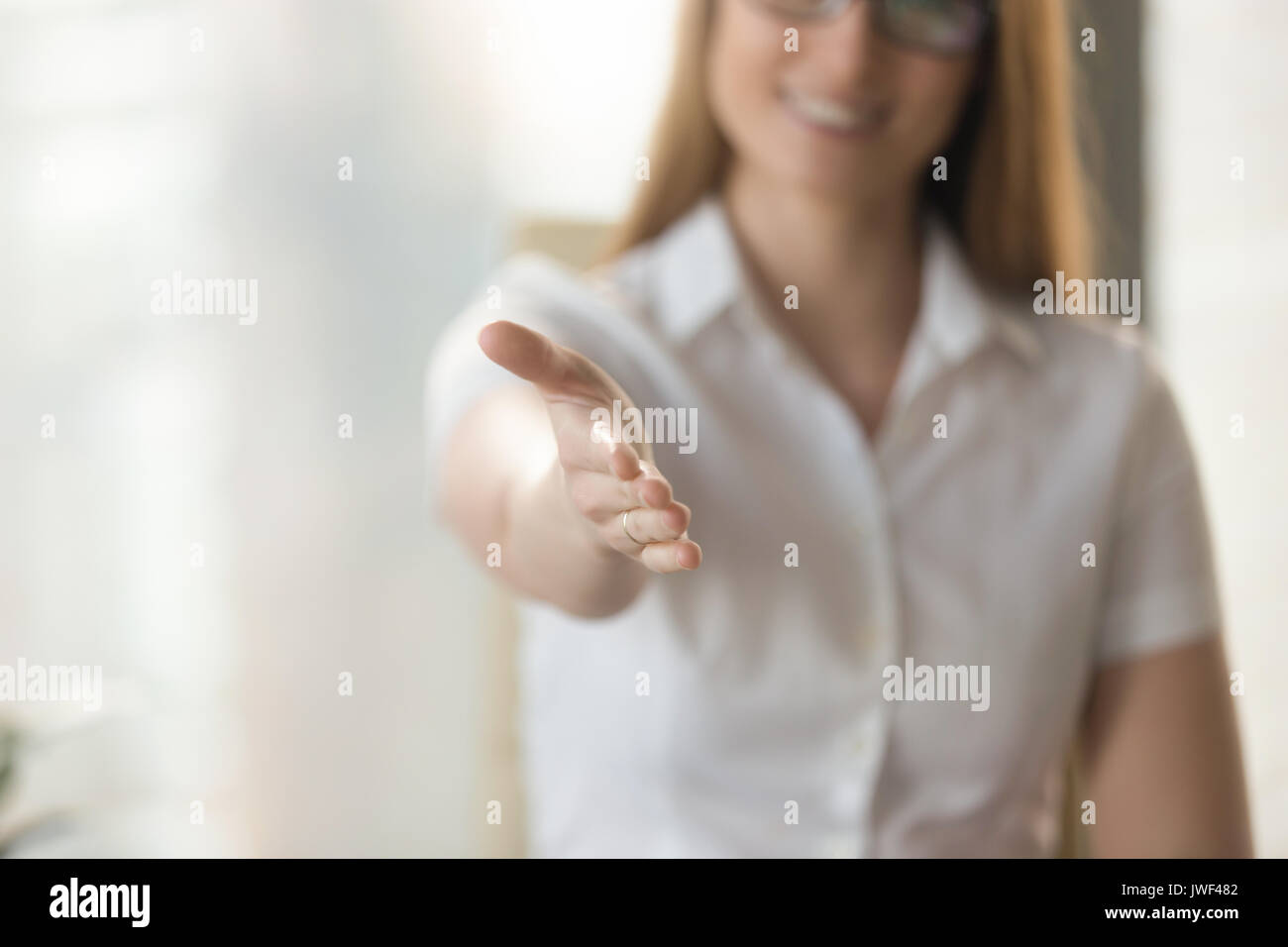 Female hand extended for handshake, welcoming to cooperation con Stock ...