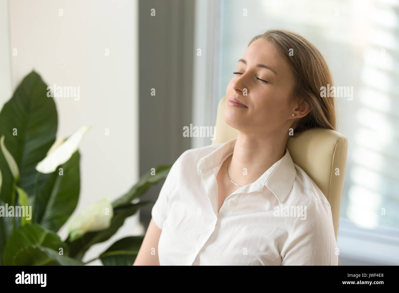 Calm attractive woman feeling relaxed leaning back on office cha Stock ...