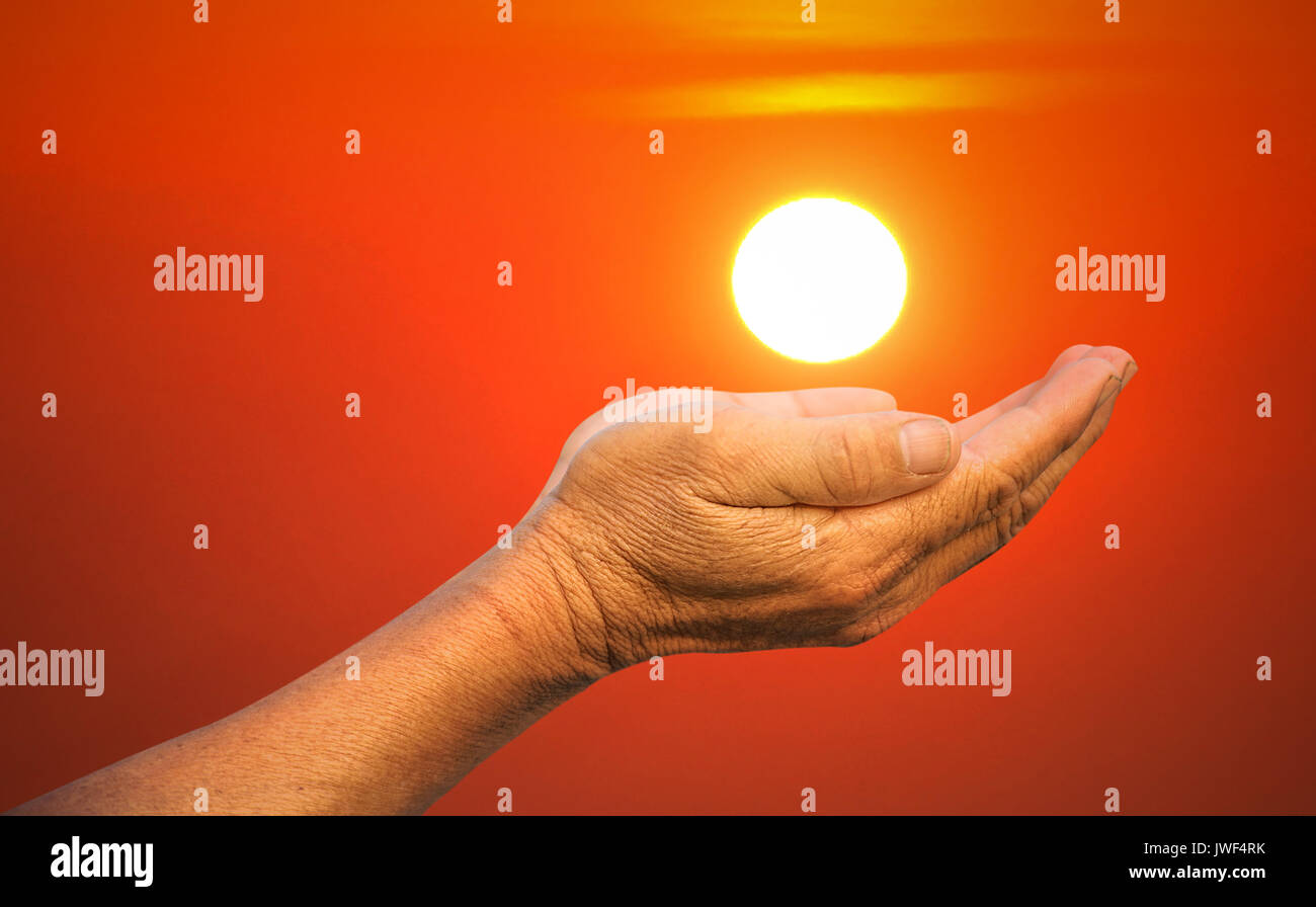 Hands holding the sun Stock Photo - Alamy