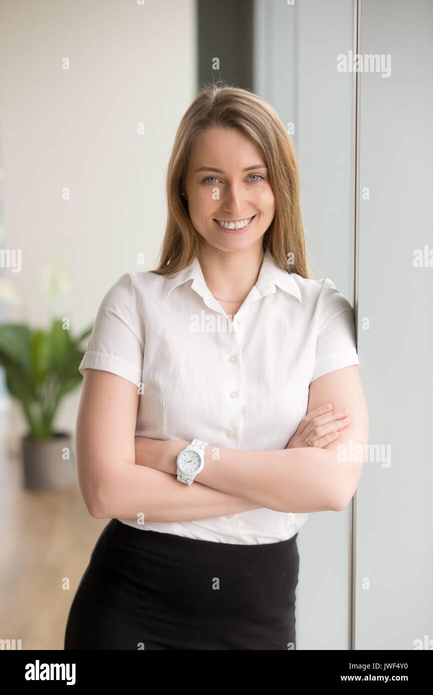 Attractive businesswoman standing office arms crossed hi-res stock ...