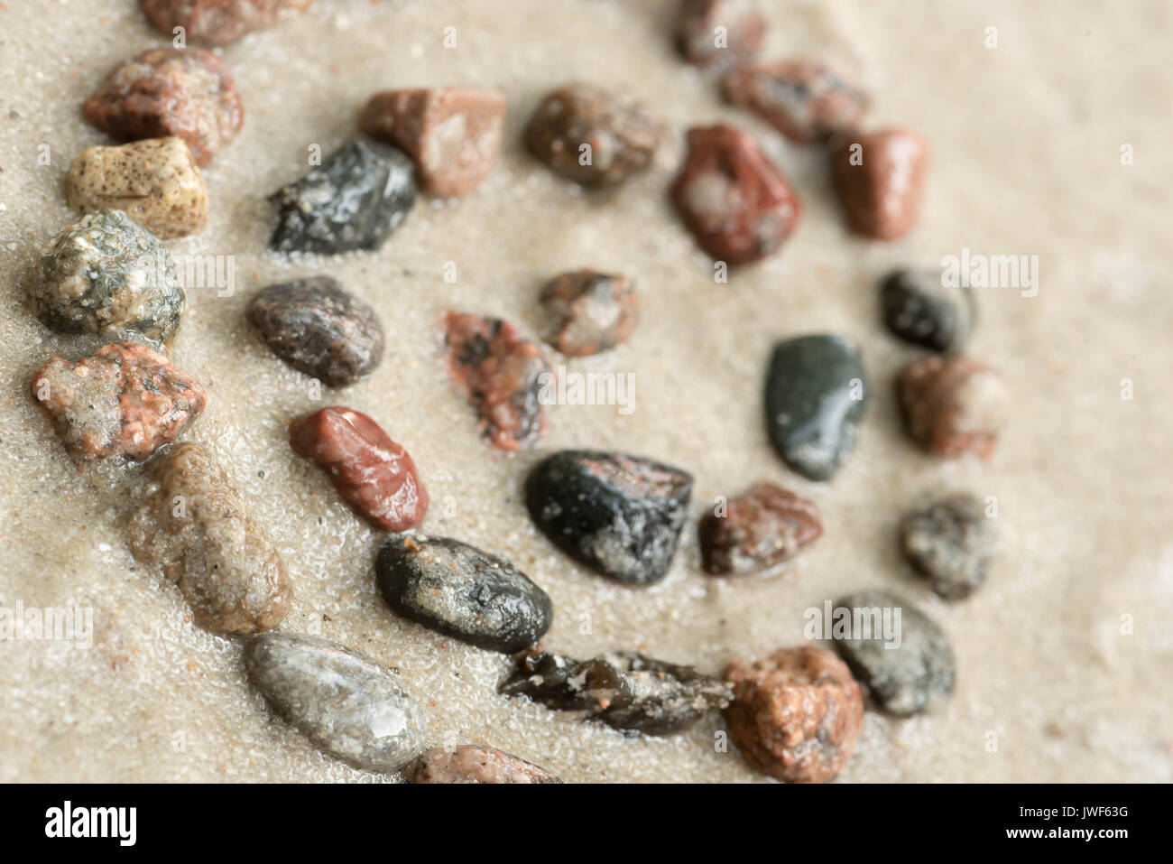 pebble helix symbol on sand background selective focus Stock Photo - Alamy