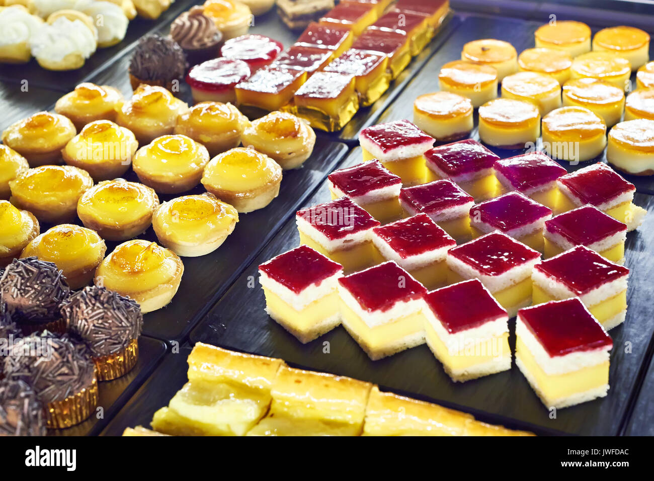 Sweet cakes in the cafe showcase Stock Photo - Alamy