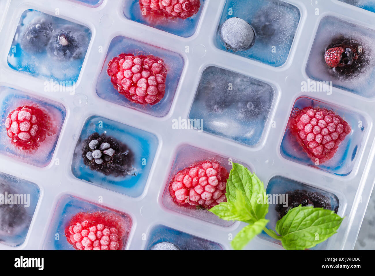 Fruit ice cubes with organic berries Stock Photo - Alamy