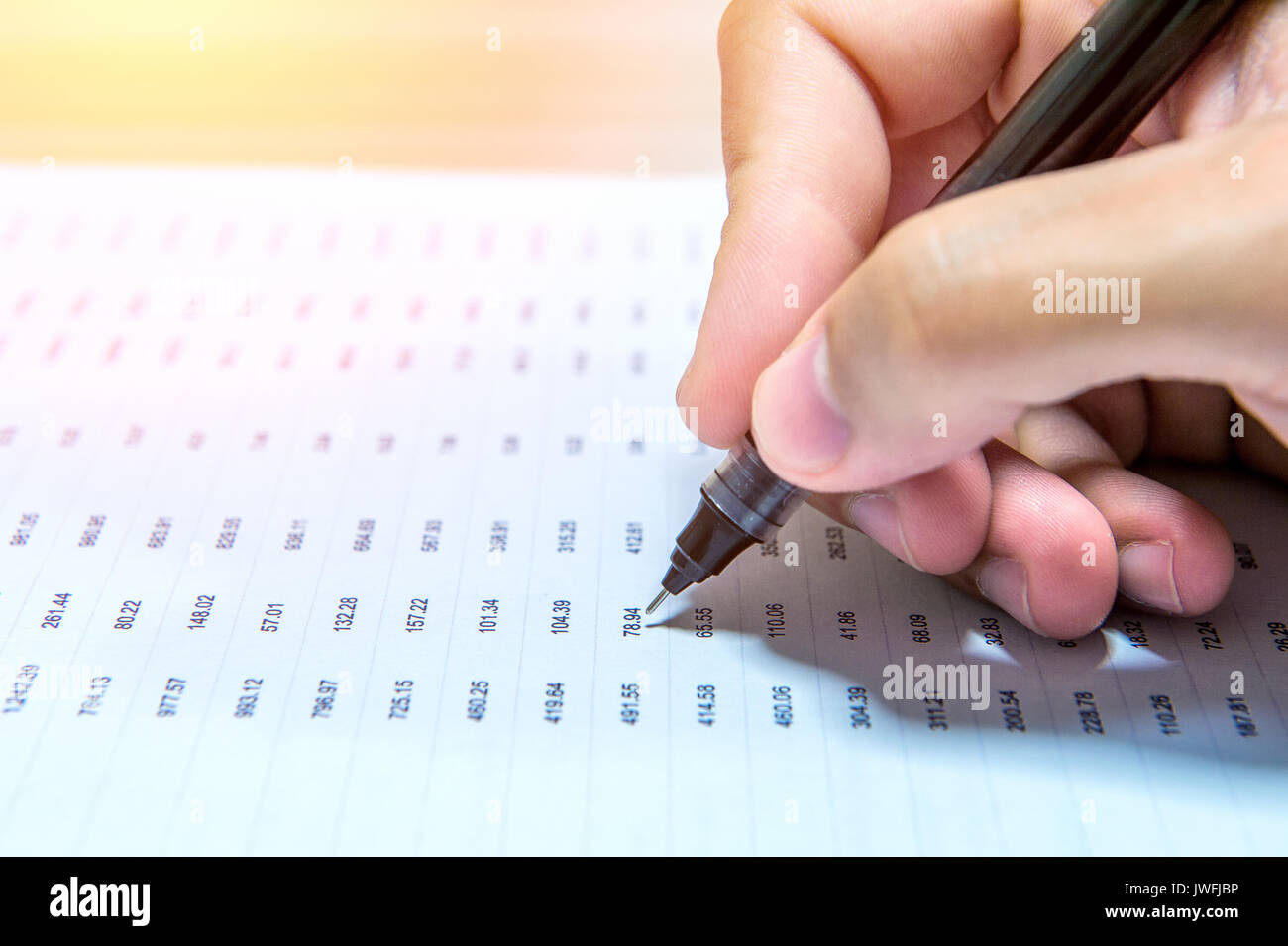 Businessman hand holding a pen working on document Stock Photo - Alamy