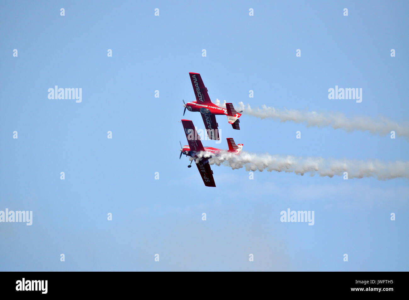 Red airplanes on the blue sky backgorund during airshow in Gdynia ...