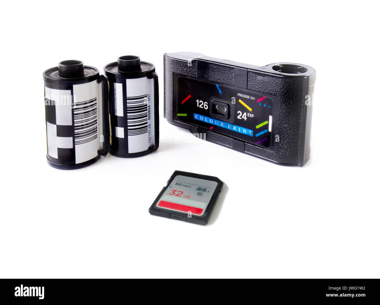 Old 35mm and 126 film cartridges and SD card isolated on a white ...