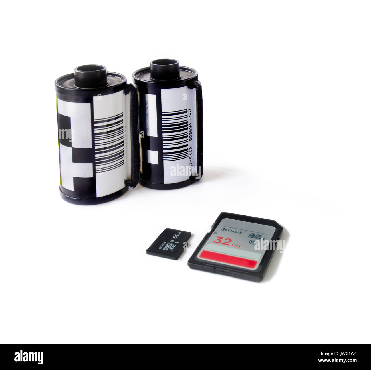Old 35mm film cartridges, SD card and micro sd card isolated on a white ...