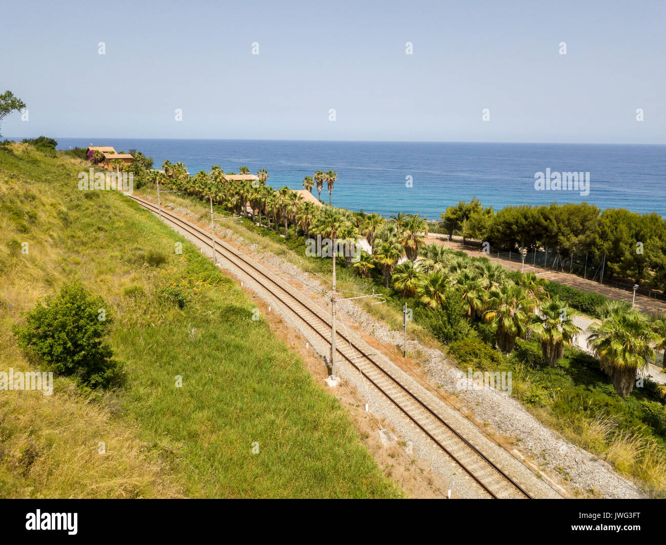 Train tracks crossing the coast with sea views, departing tourist ...