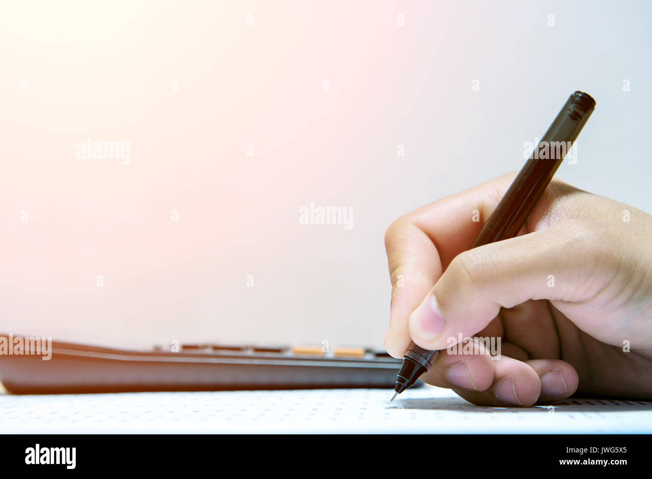 Businessman hand holding a pen working on document Stock Photo - Alamy
