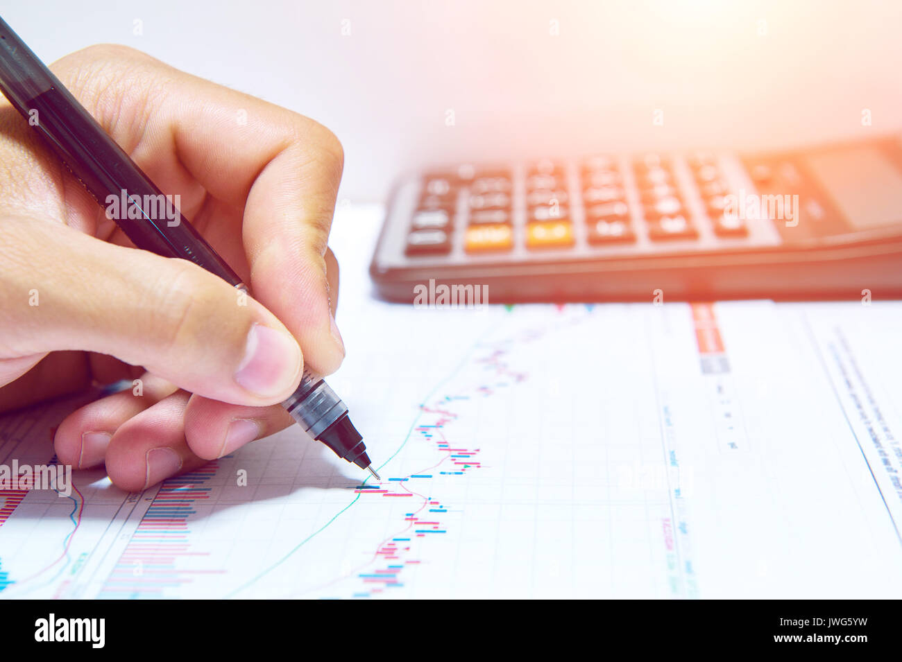 Businessman hand holding a pen working on document Stock Photo - Alamy