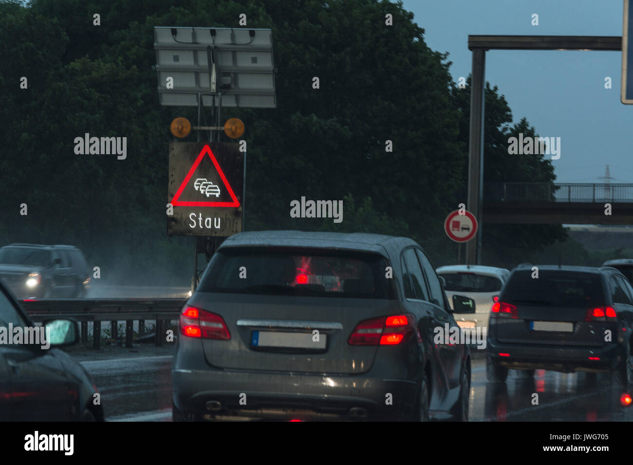 Danger of a traffic jam in heavy rain. Severe weather on the highway ...