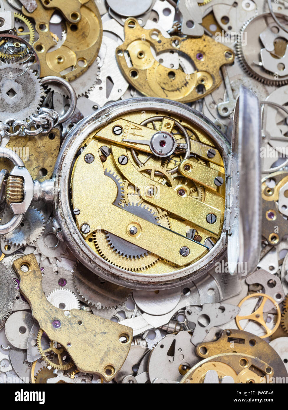 watchmaker workshop - open old silver pocket watch with brass clockwork ...