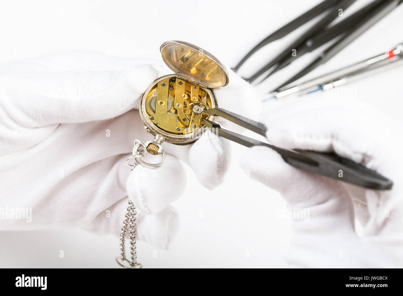 watchmaker workshop - adjusting of old pocket watch by tweezers Stock ...