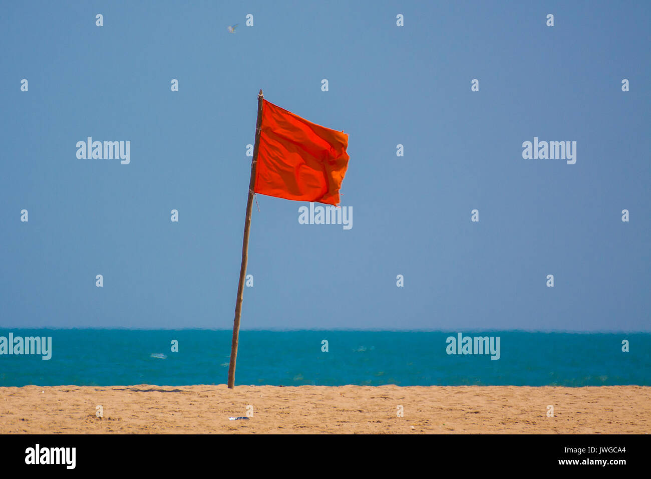 Red Warning flag on beach Stock Photo - Alamy