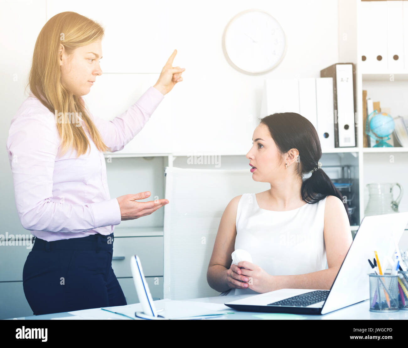 Female senior manager telling off her co-worker during working day ...
