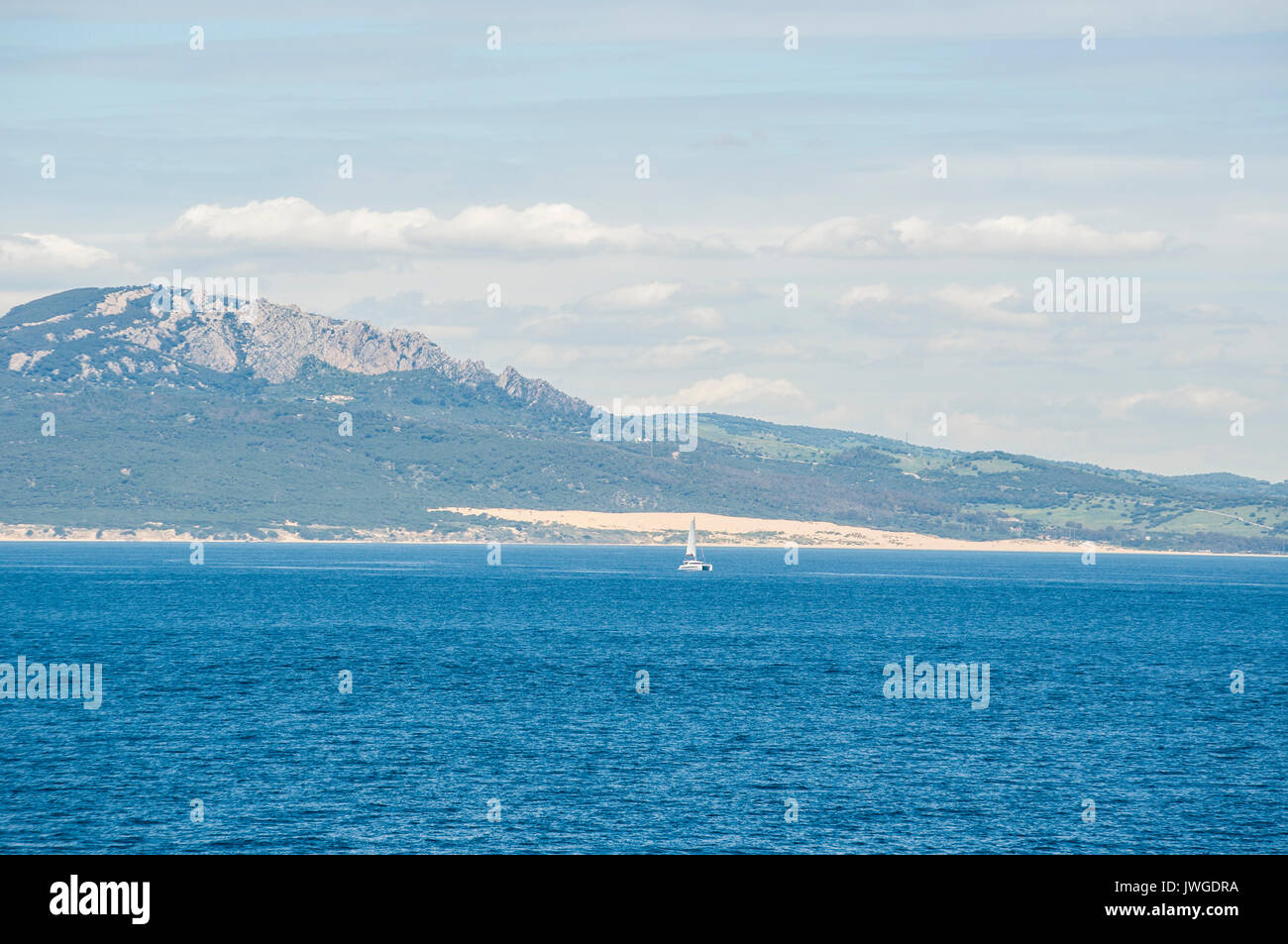 a sailboat near Tarifa seen from the Strait of Gibraltar that connects ...