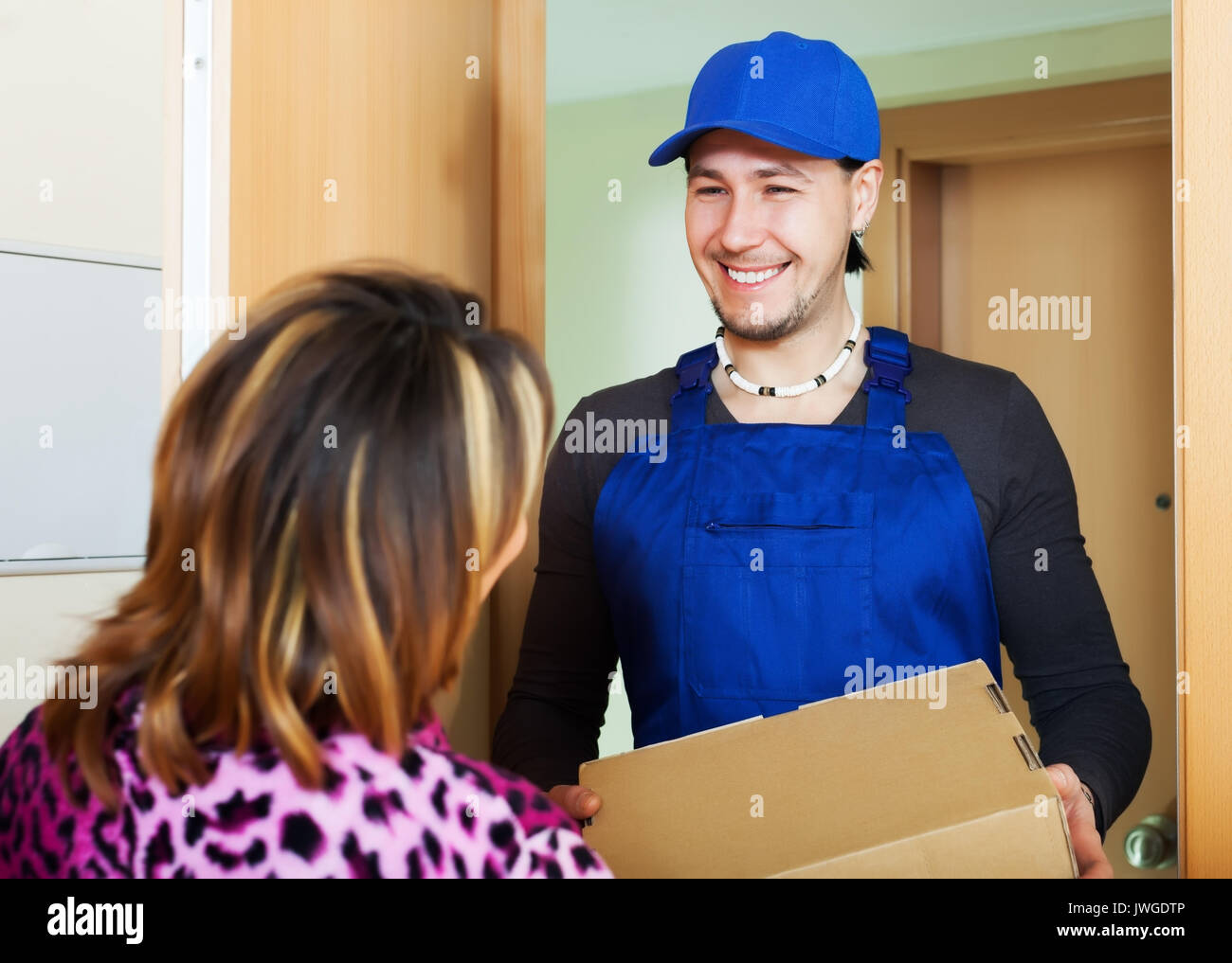 Postman in uniform delivered parcel hi-res stock photography and images ...