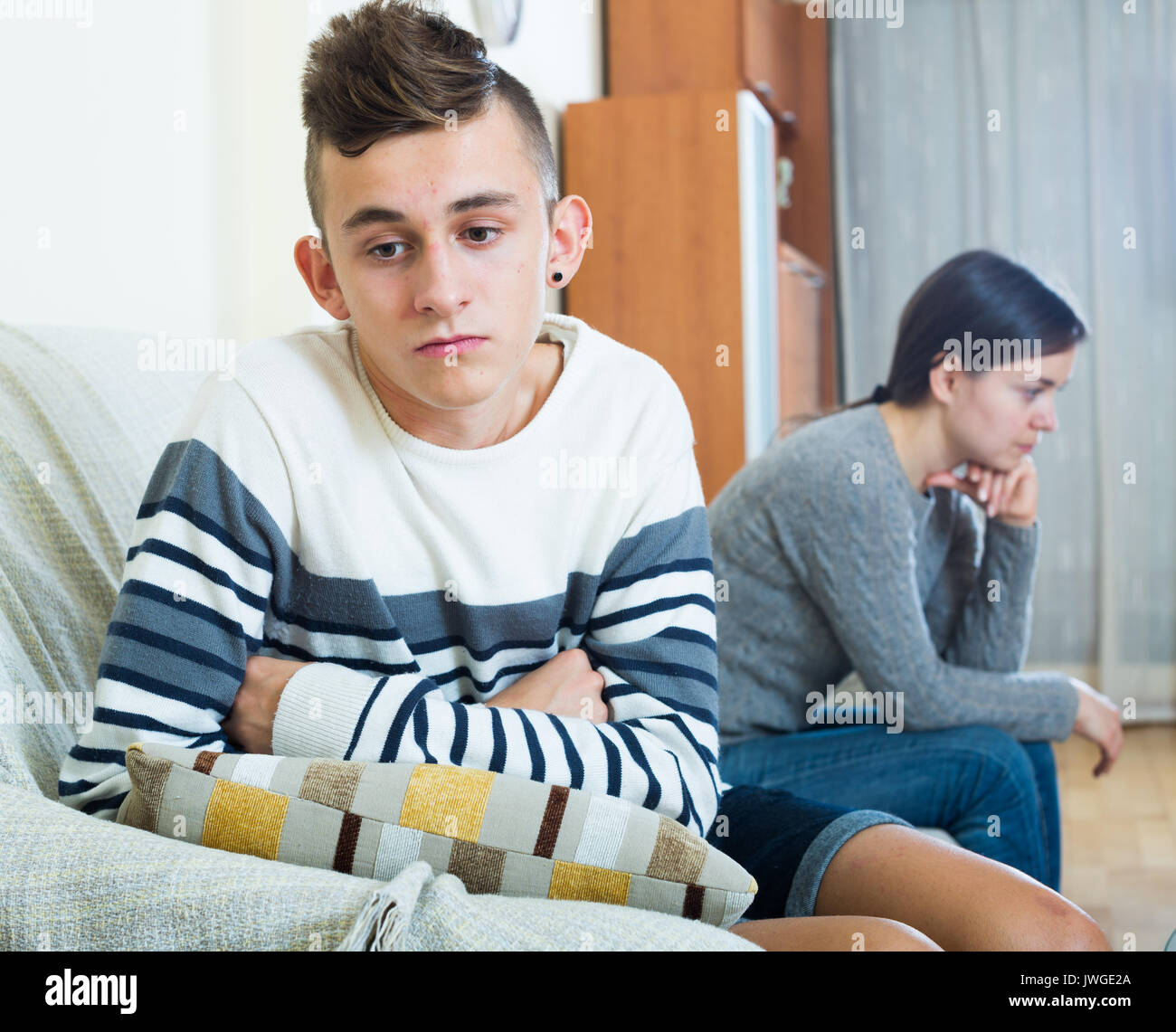 Upset mother and angry son arguing in domestic interior Stock Photo - Alamy