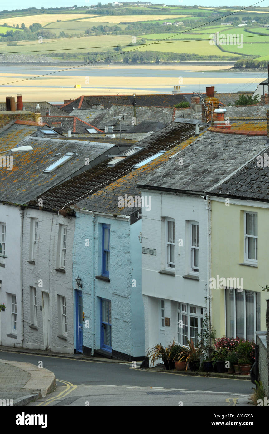 terraced houses painted in different colours on a hill street in ...