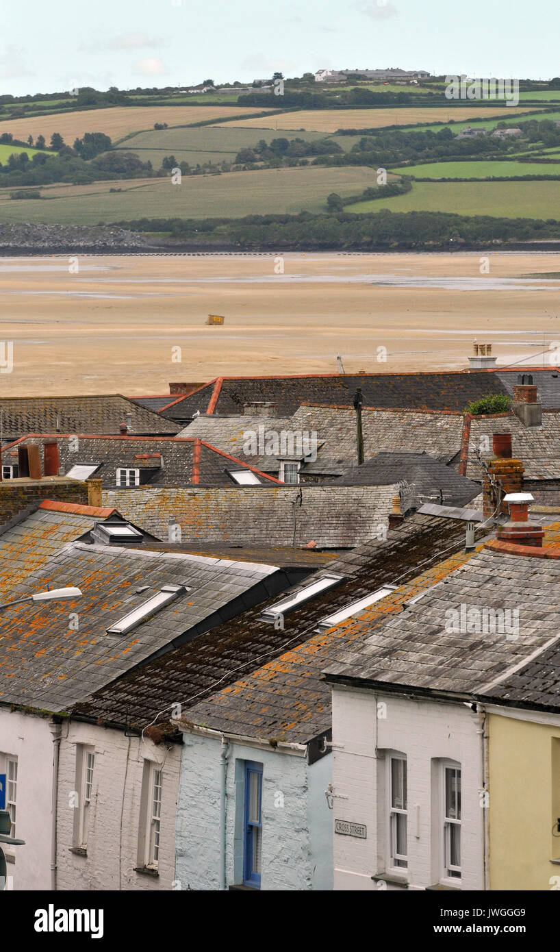 terraced houses painted in different colours on a hill street in ...