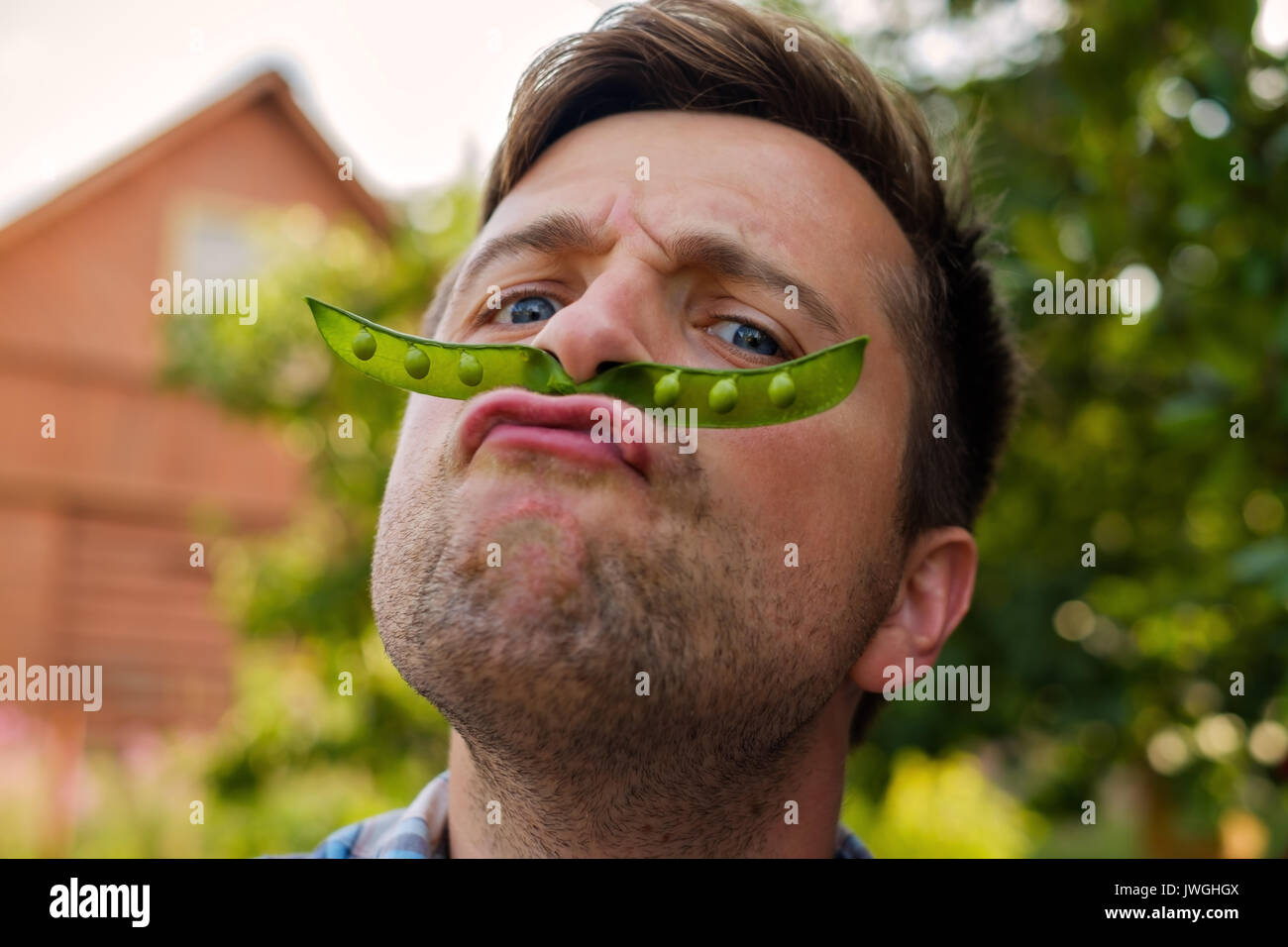 young funny man makes a funny face Stock Photo - Alamy
