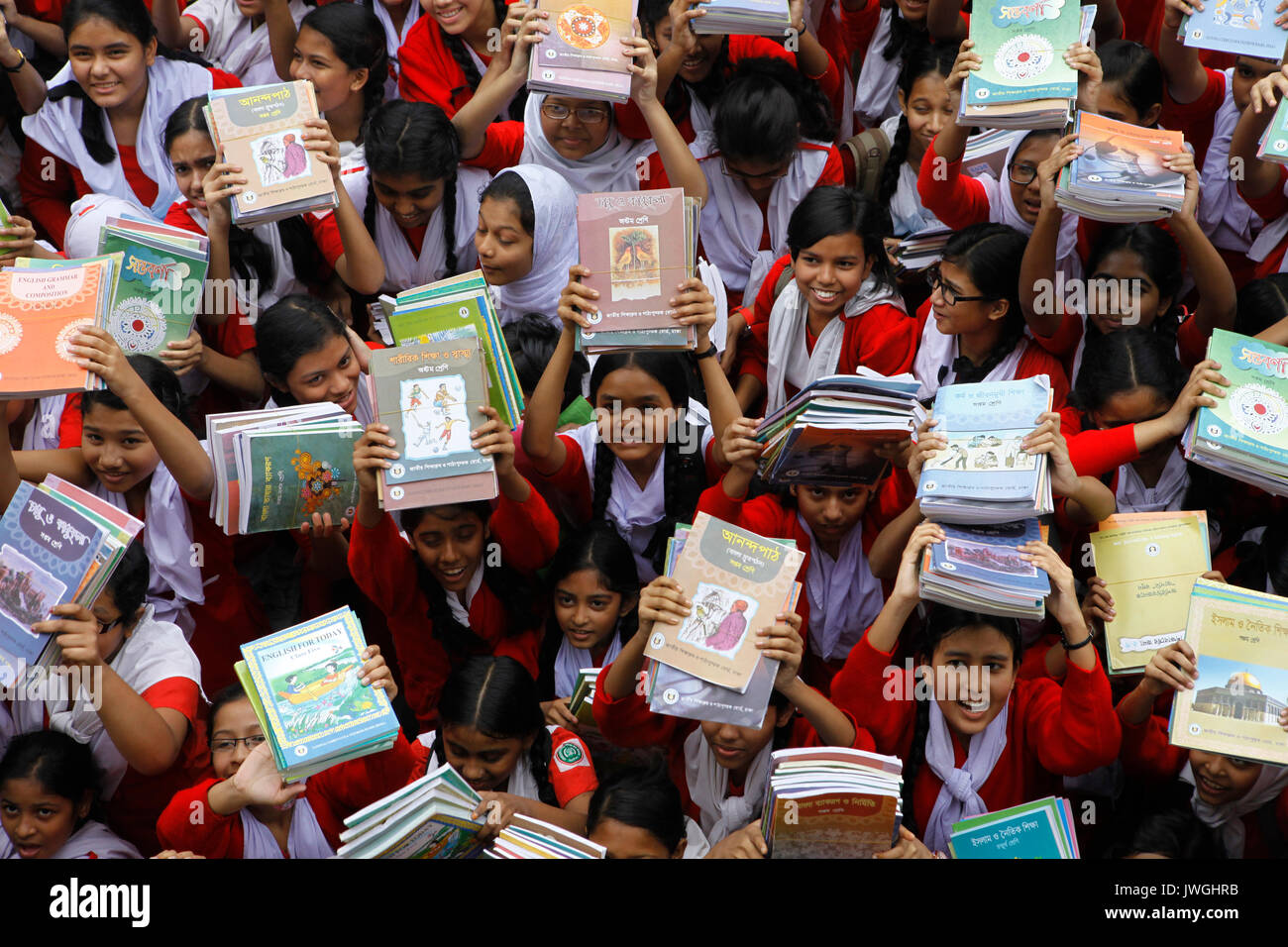 Students from primary and secondary level cheering with new textbooks ...
