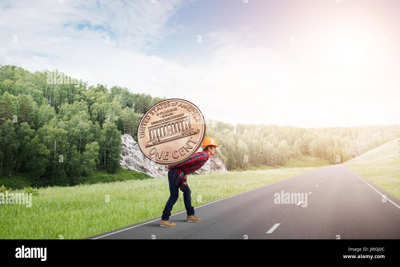 Builder man carry coin Stock Photo - Alamy