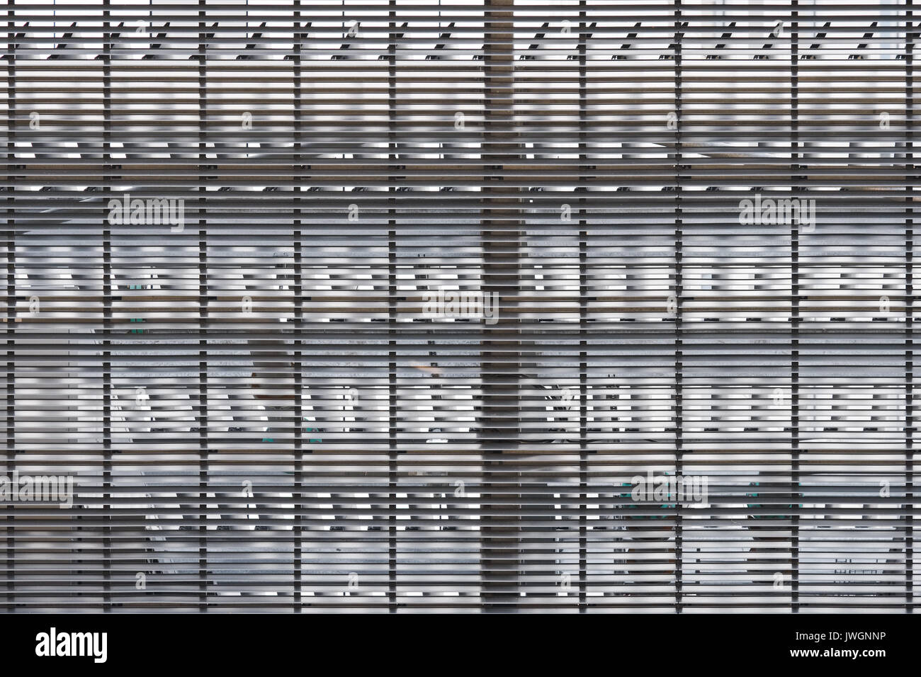 An abstract close-up of a section of a grate outside a modern building ...