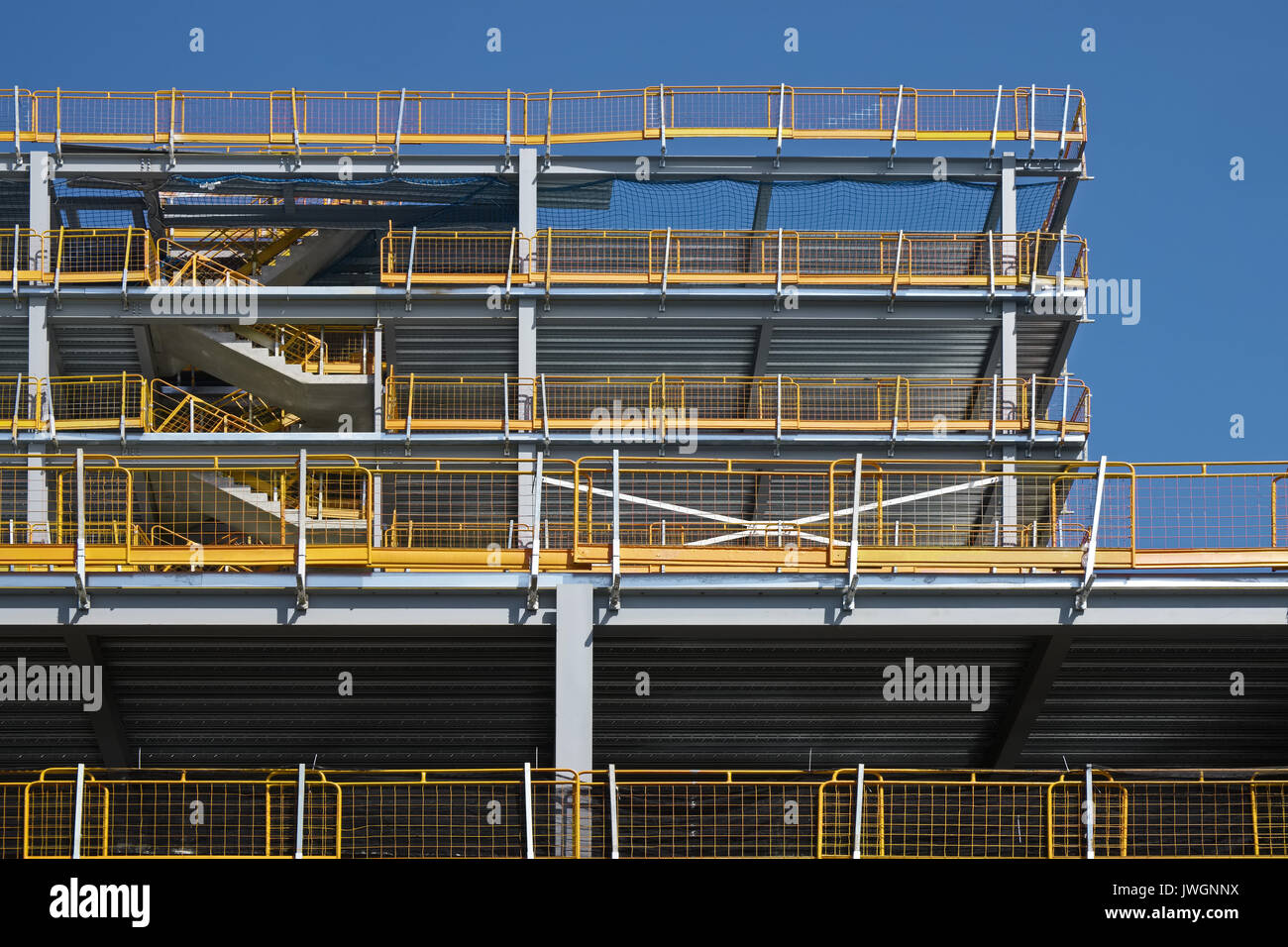 Building construction site showing steel frame with yellow safety ...