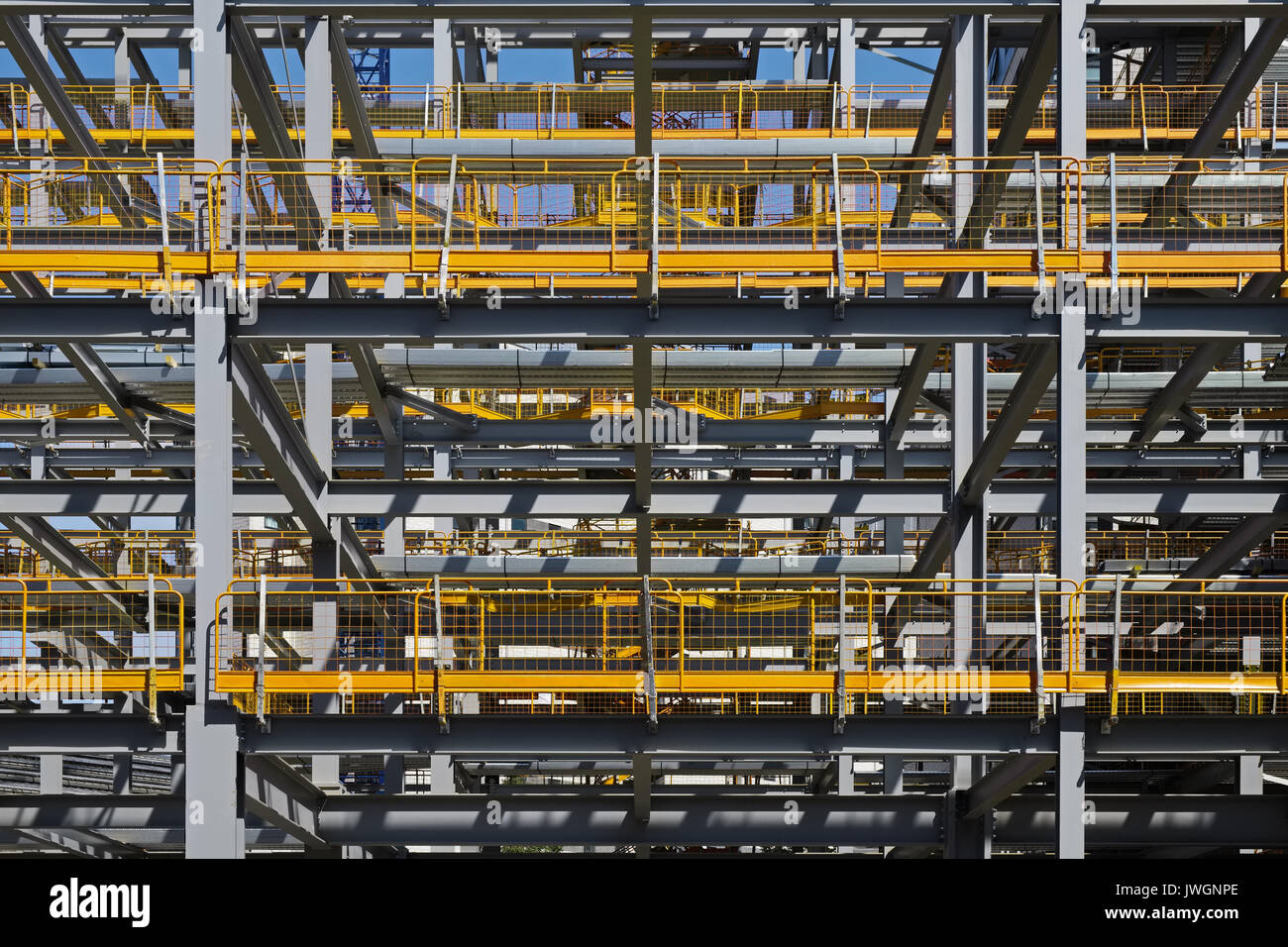 Building construction site showing steel frame with yellow safety ...