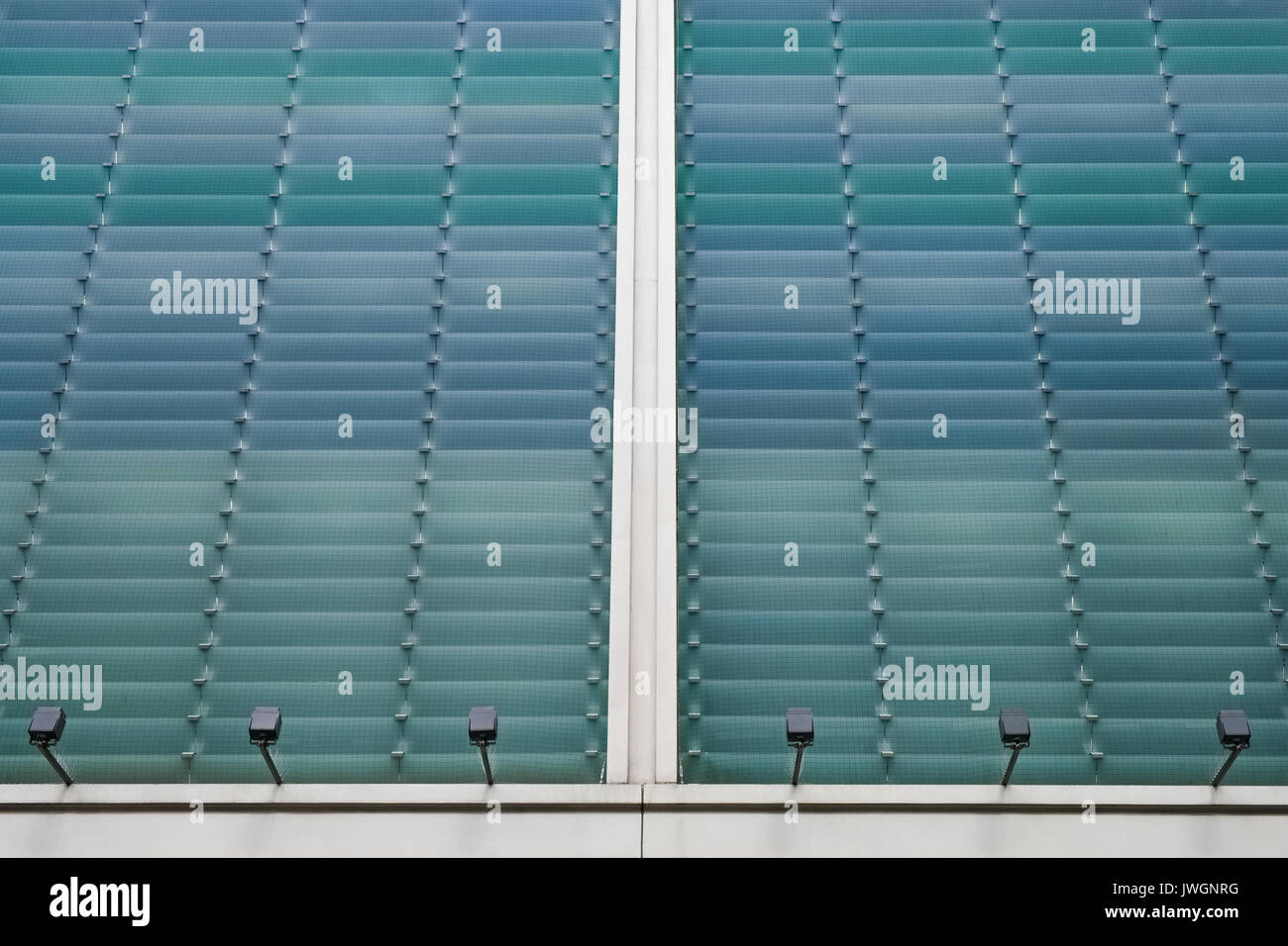 An abstract close-up of a section of a modern building showing a glass ...