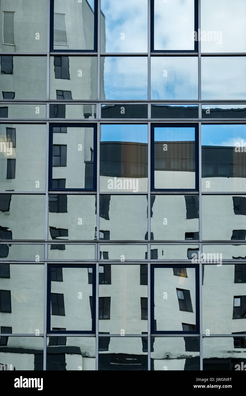 An abstract close-up of a section of a modern building reflecting ...