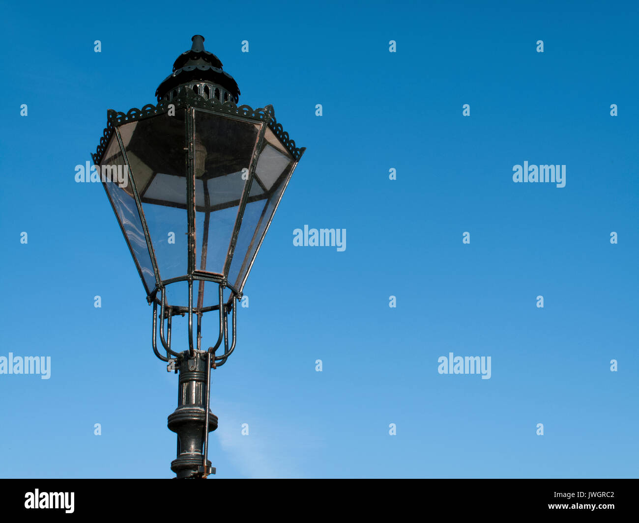Period styled cast iron streetlamp against a clear blue sky Stock Photo ...