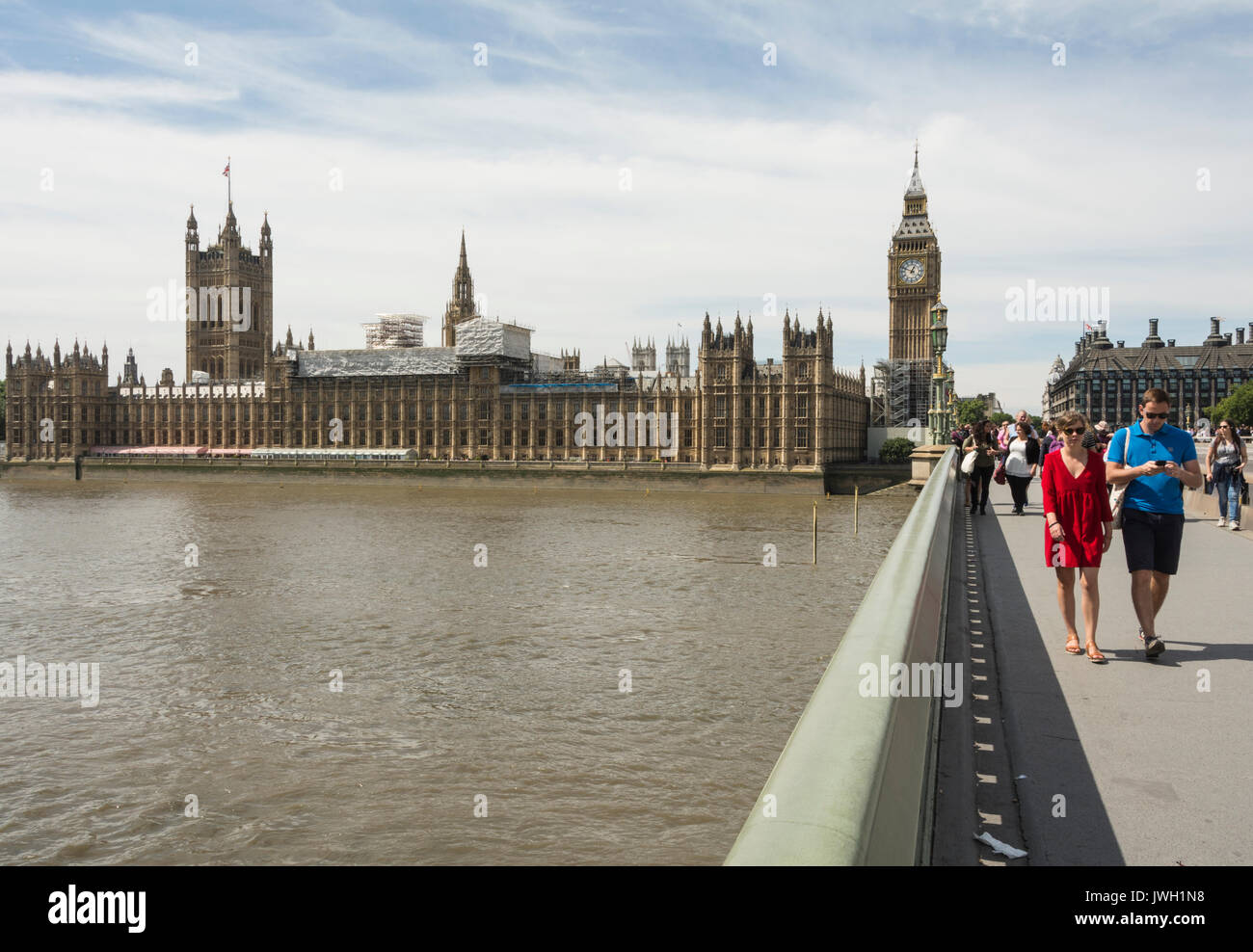 Pedestrians on Westminster Bridge outside the Houses of Parliament on ...