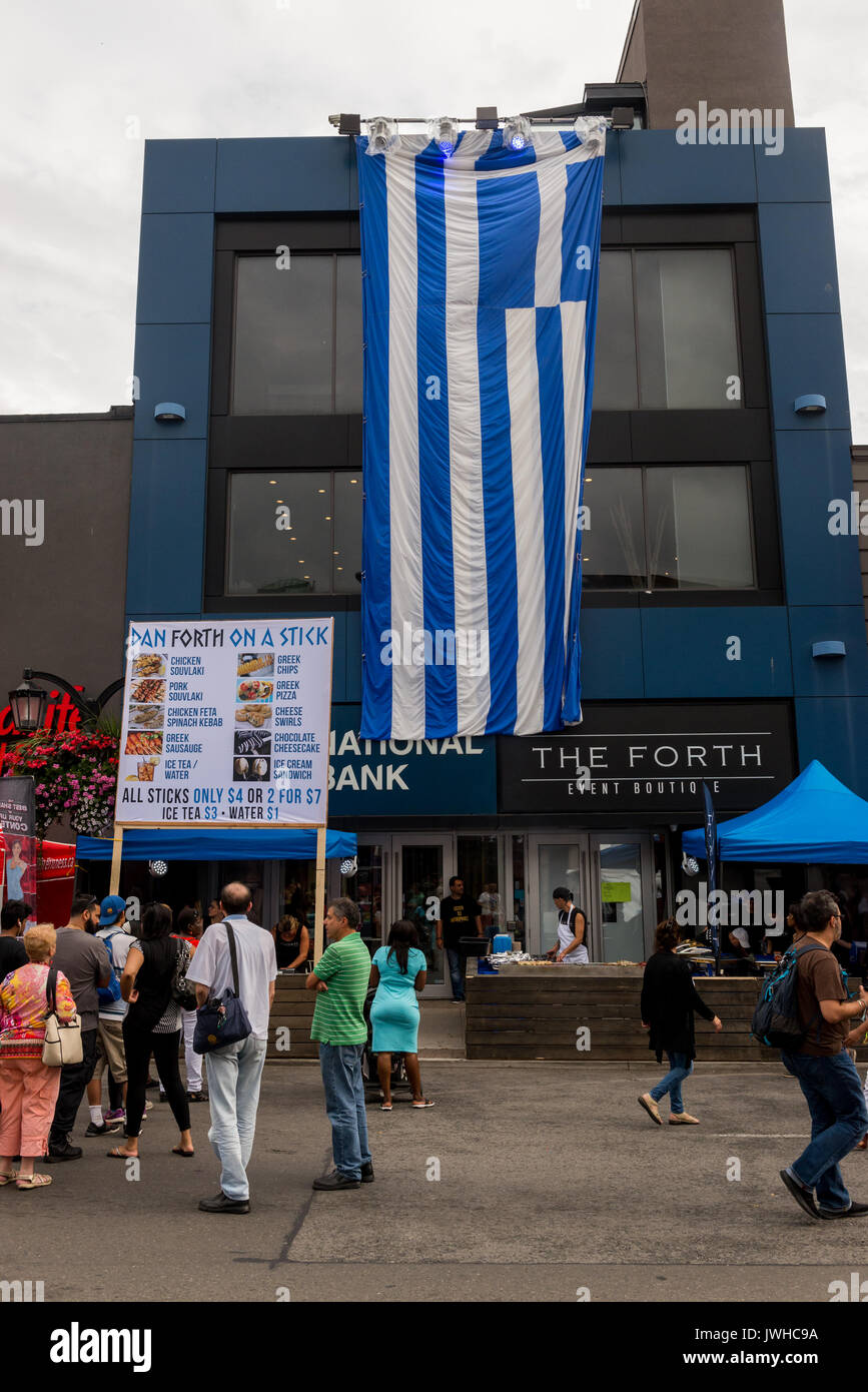 People are walking on the Danforth Avenue in the Greektown district of ...
