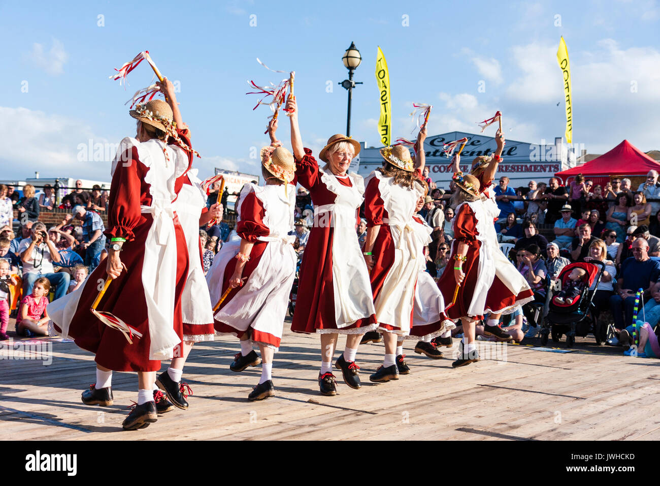 Traditional womens Morris dancers, The Rising Larks. Wearing orange ...