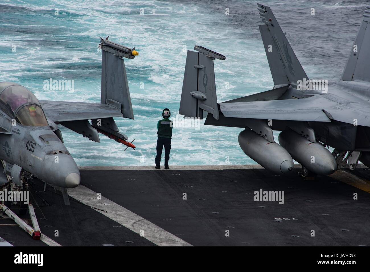 Pacific Ocean. 11th Aug, 2017. A U.S. Navy sailor watches a strait ...