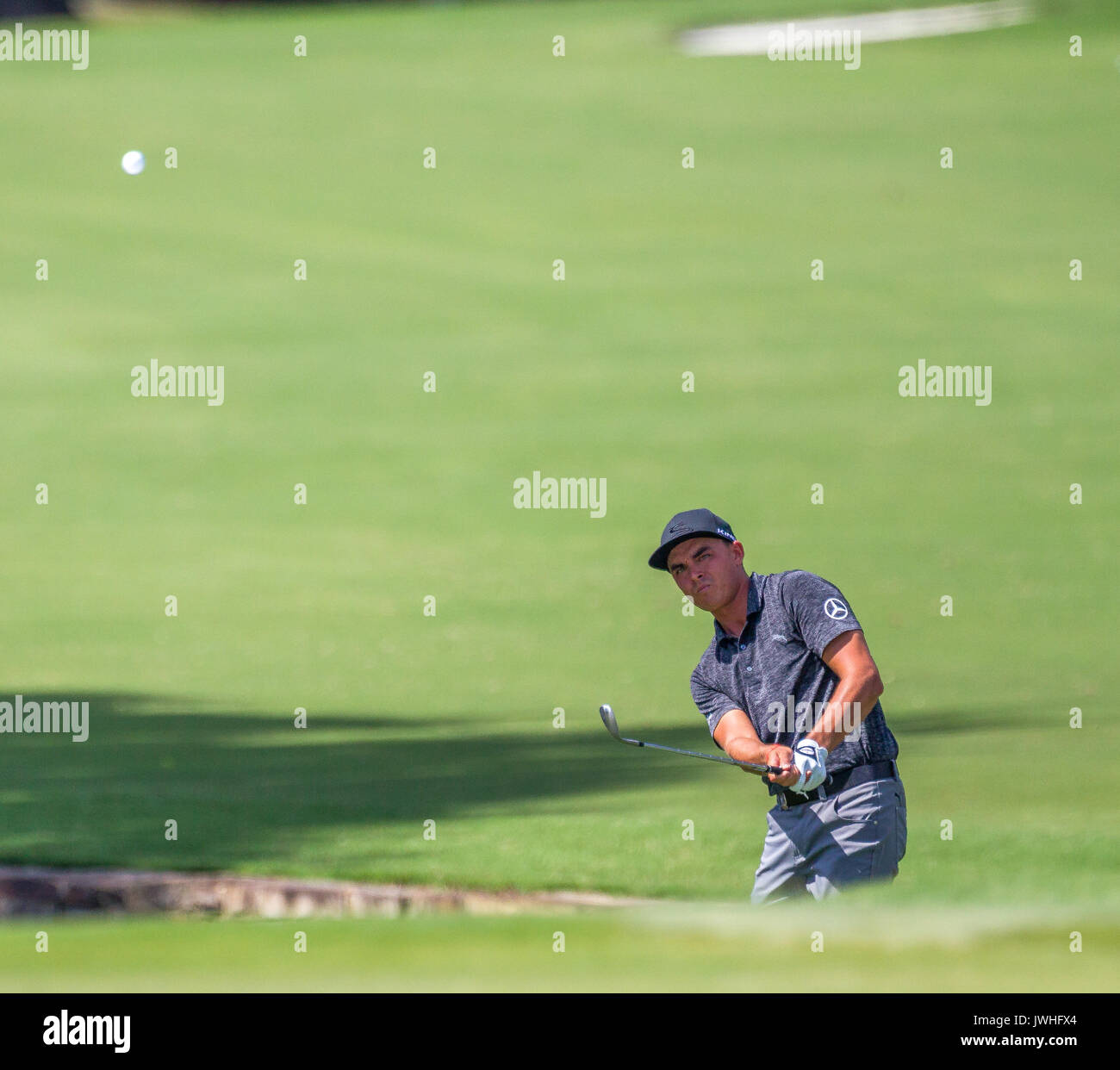 August 12, 2017: Rickie Fowler of the United States chips onto the on ...