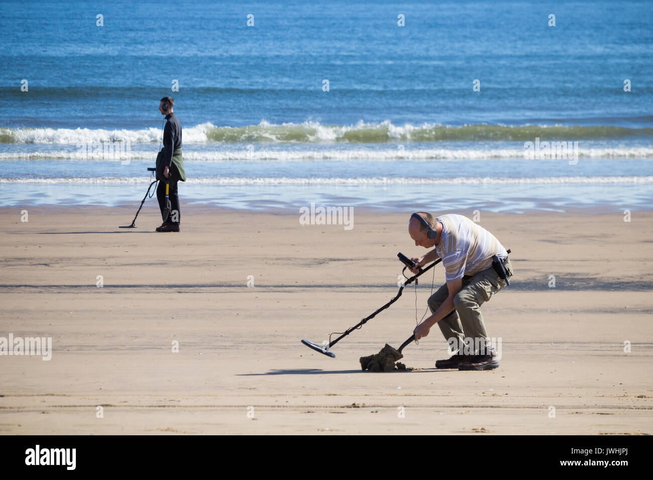 Metal detectorists on beach. UK Stock Photo - Alamy
