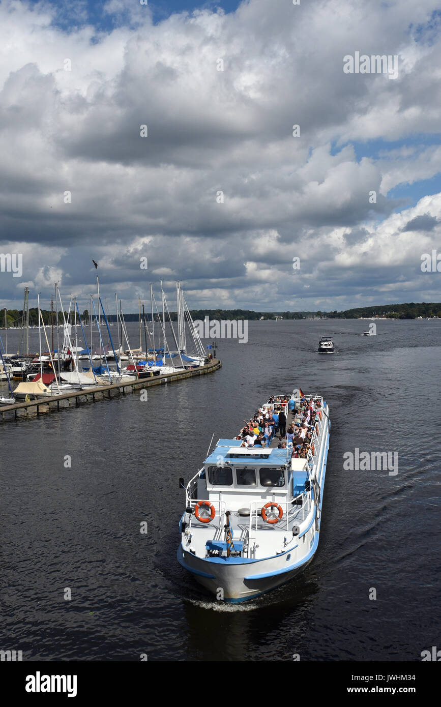 A river tour boat makes its way across the Wannsee lake on a partly ...